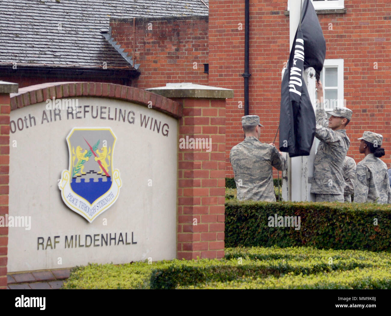 U.S. Air Force Airmen from the 100th Air Refueling Wing lower the POW ...