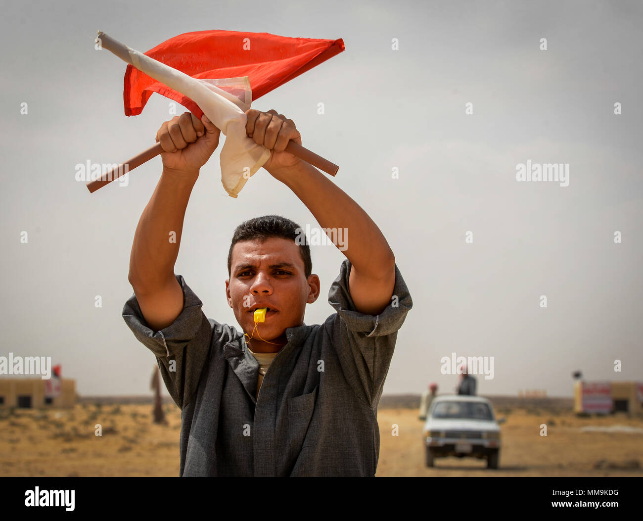 An Egyptian service members signals troops during an Egyptian military ...