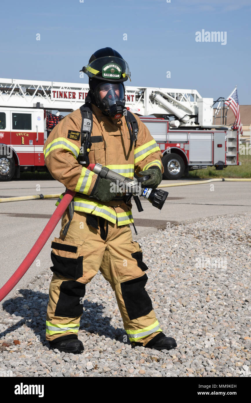 Members of the Tulsa Fire Department conduct training using a full-size ...