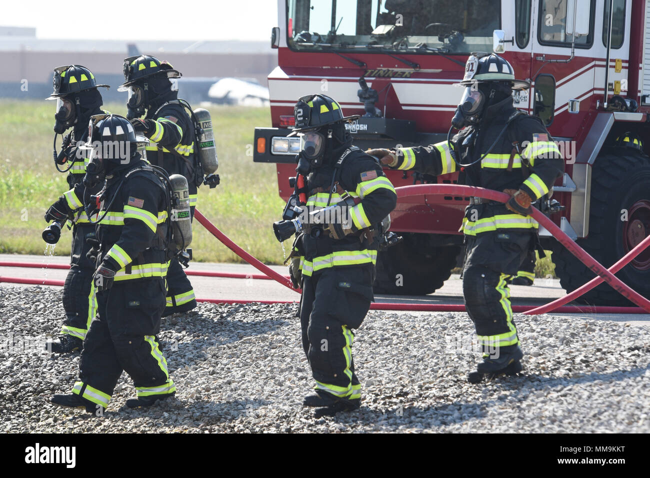 Members of the 72nd Civil Engineer Squadron, fire department, approach ...