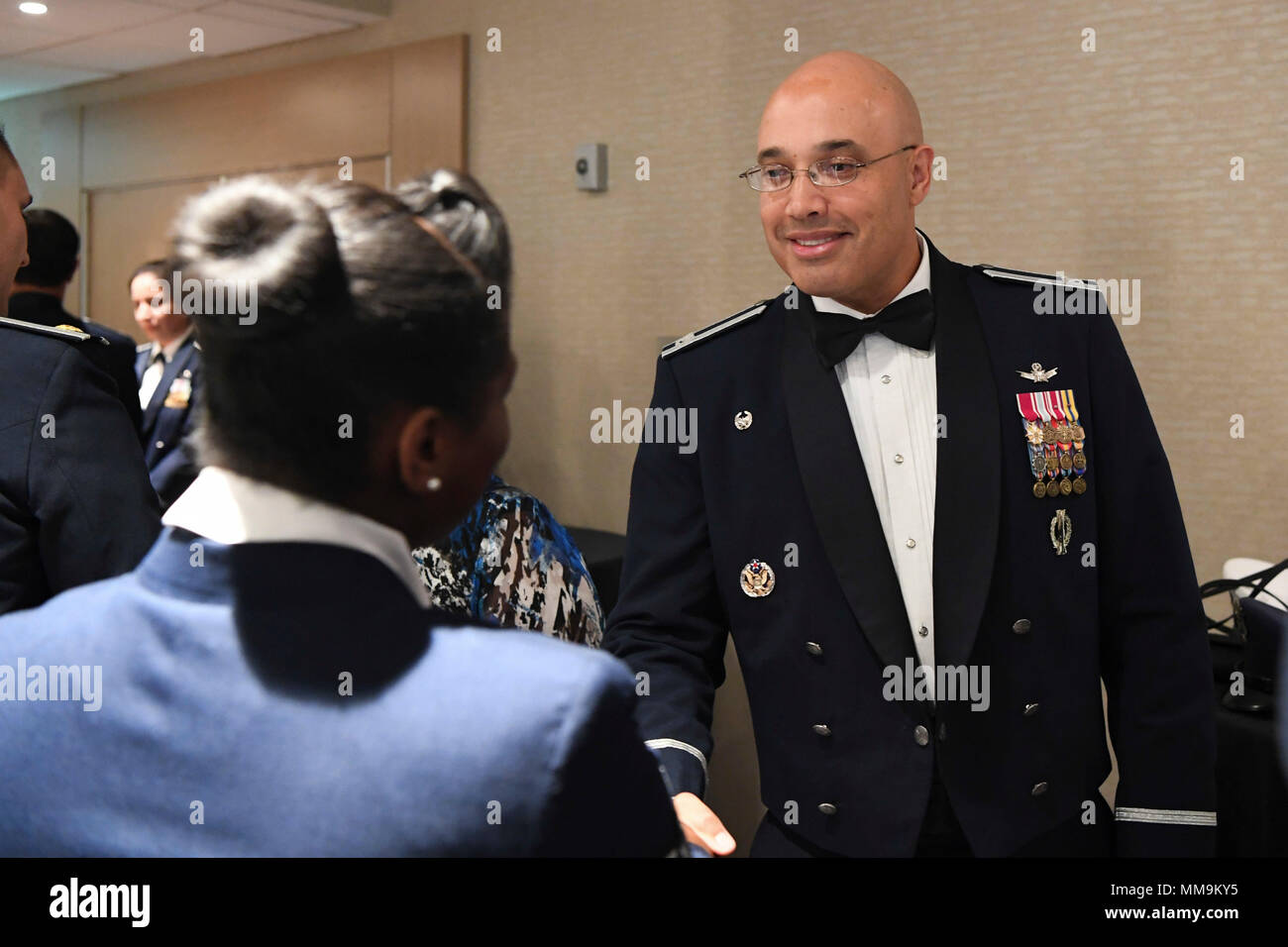 Col. David Miller, Jr., 460th Space Wing commander, greets a Team ...