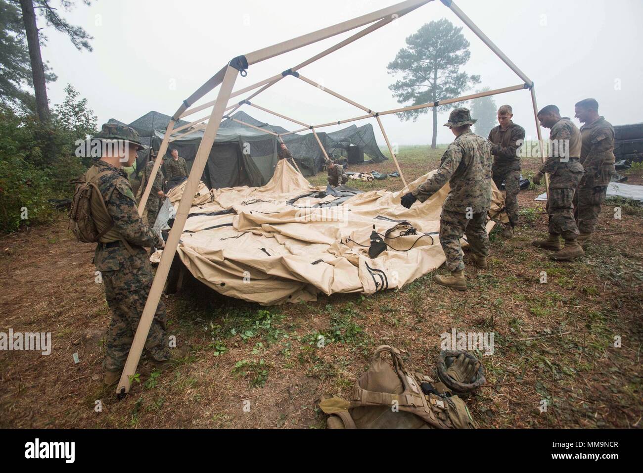 Marines disassemble a tent for a tactical displacement during a ...