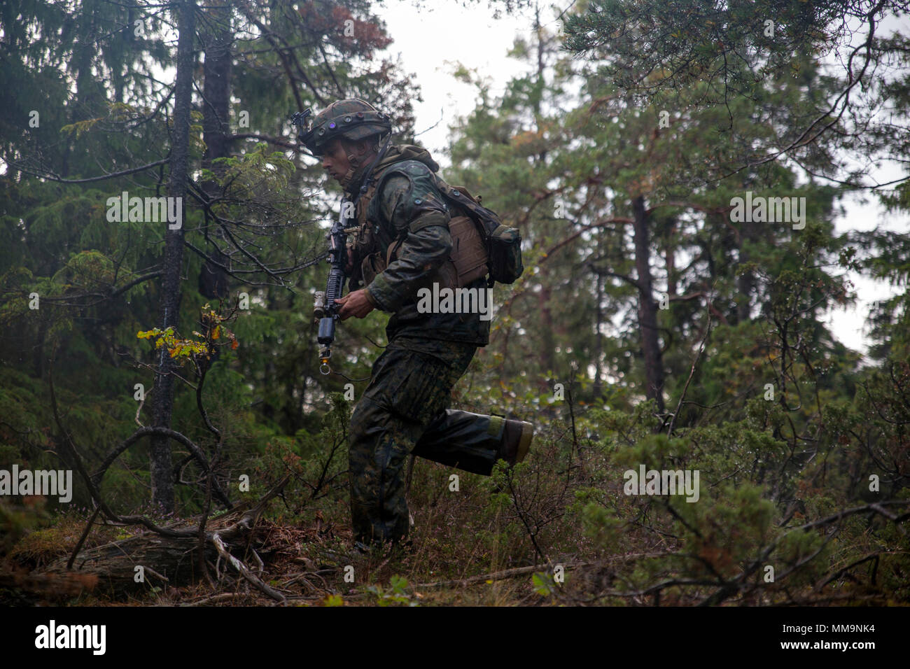 Marine with Marine Rotational Force-Europe runs between fighting ...