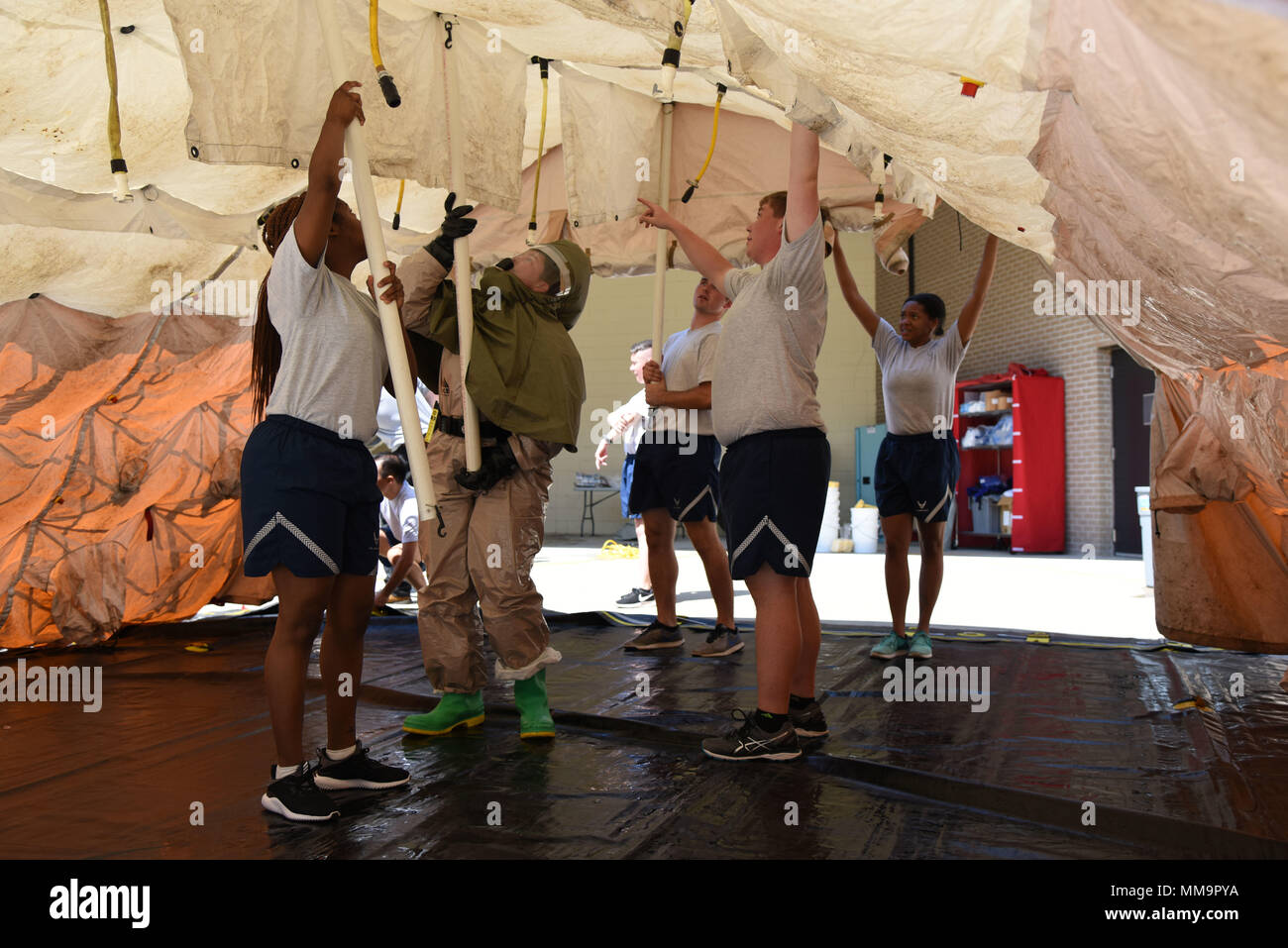 Members of the 81st Medical Group assemble a decontamination tent ...