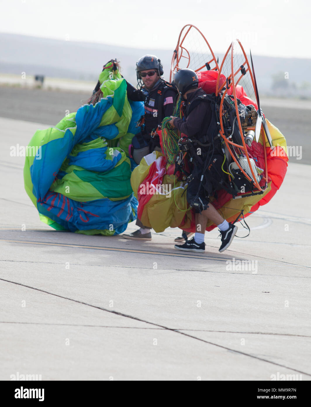 Remote control flyers and paramotors gather their paraglider wings ...