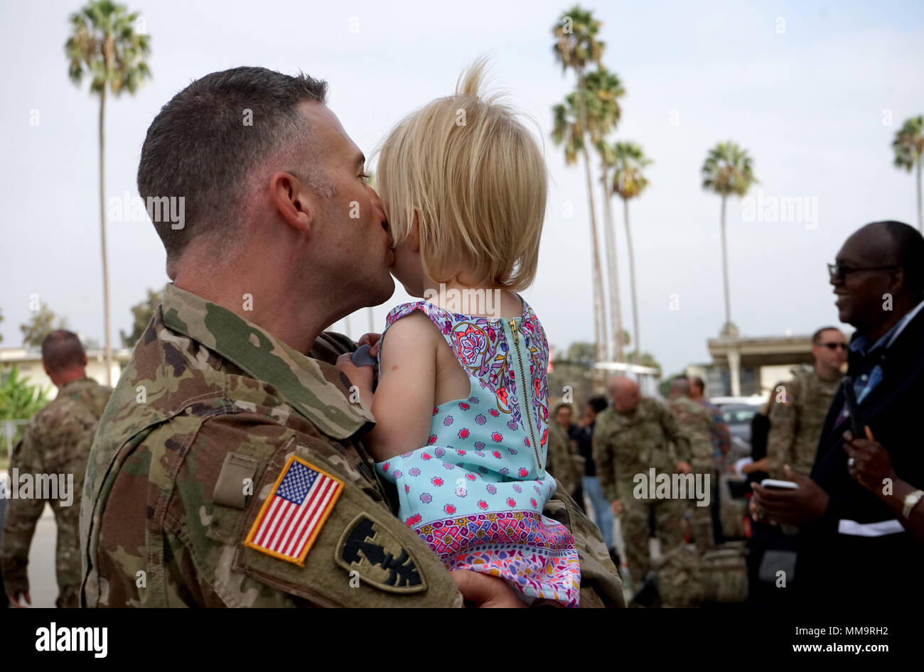 A Soldier with the CalGuard’s 40th Infantry Division kisses his ...