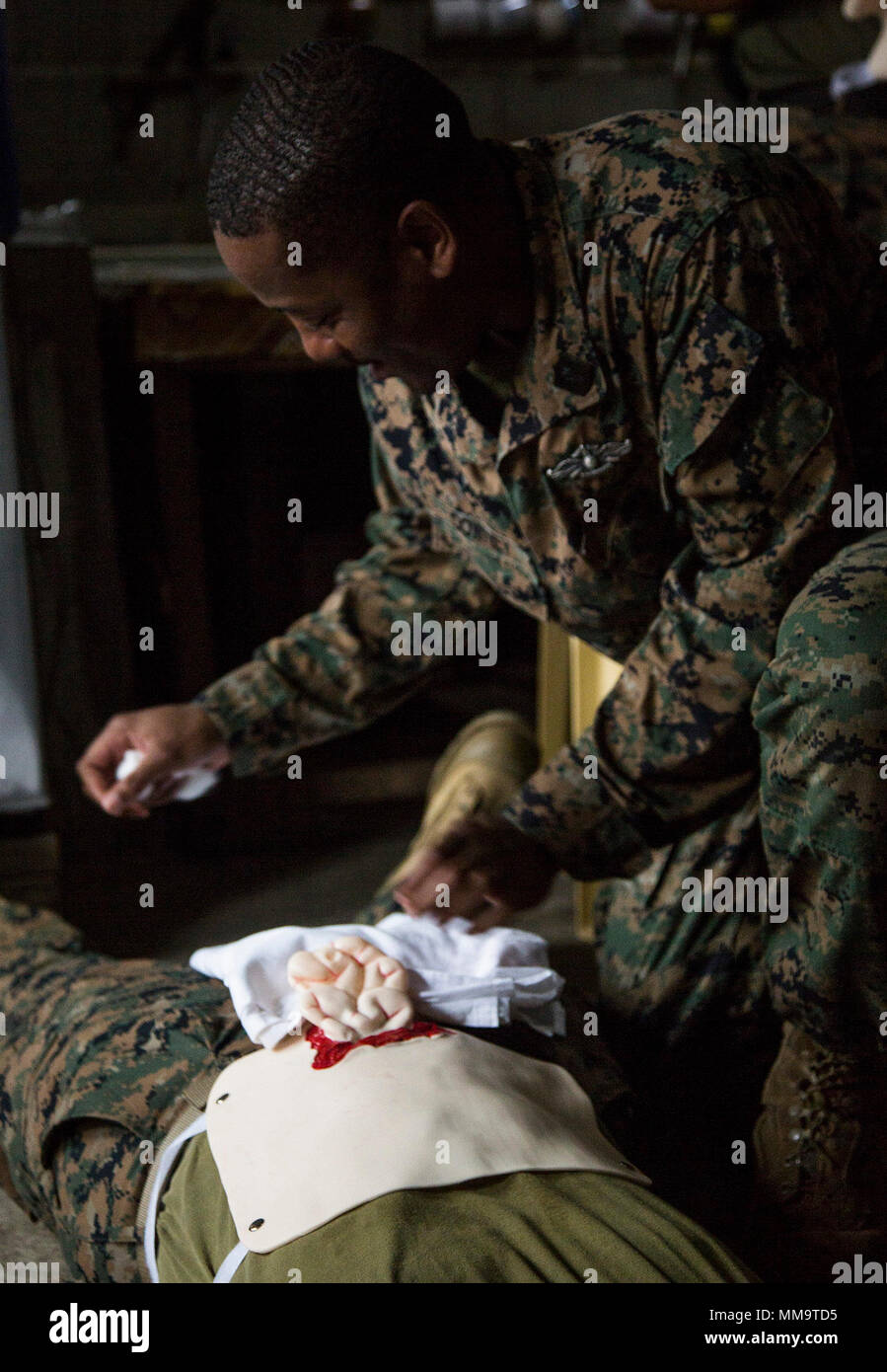 U.S. Navy HM1 Michael Downey walks through the process of some first ...