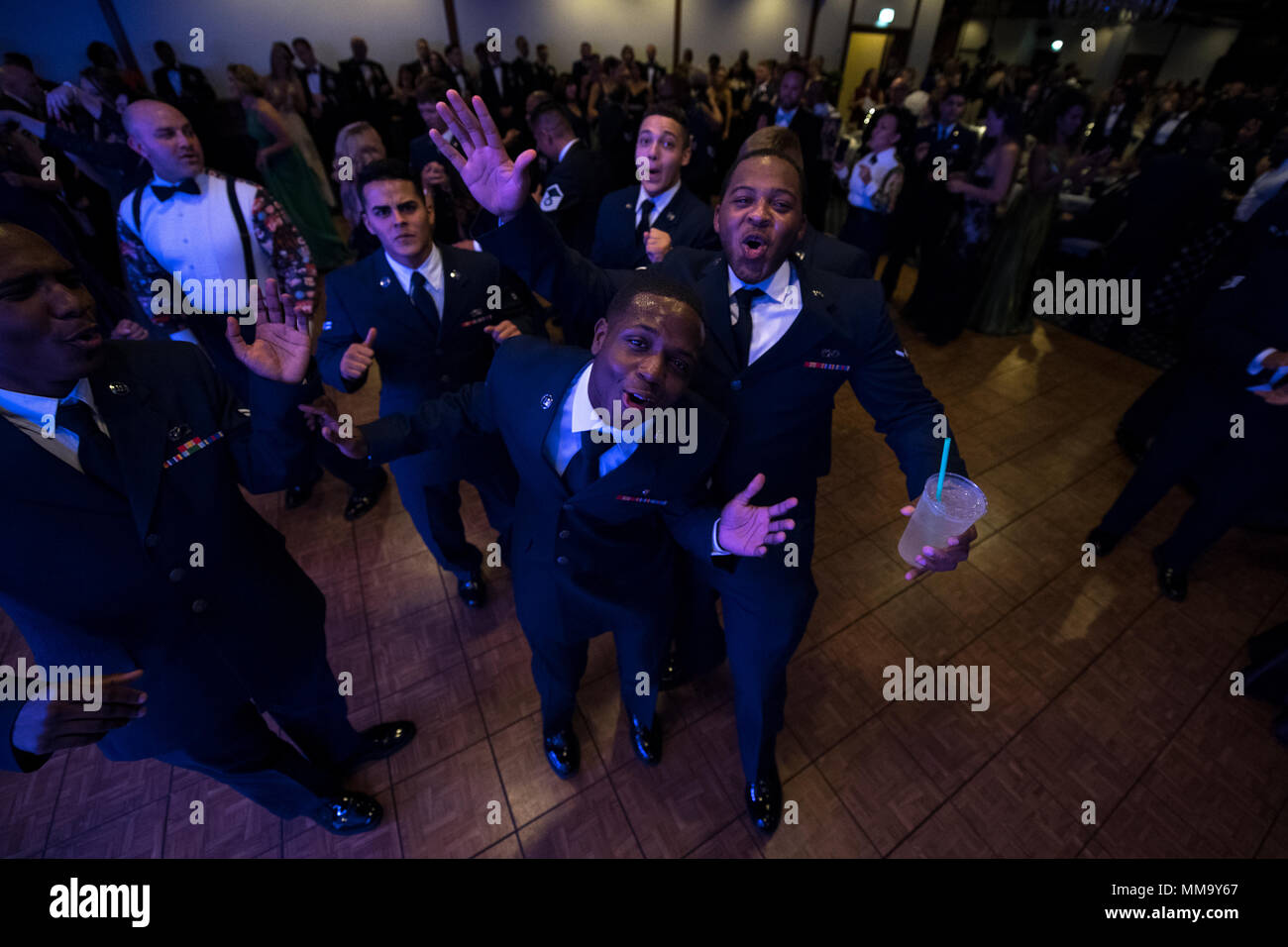 U.S. Airmen dance in a group during the Air Force Ball at the officer’s ...