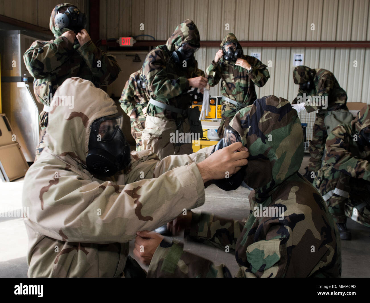 U. S. Air Force Airmen check each other’s protective equipment to ...