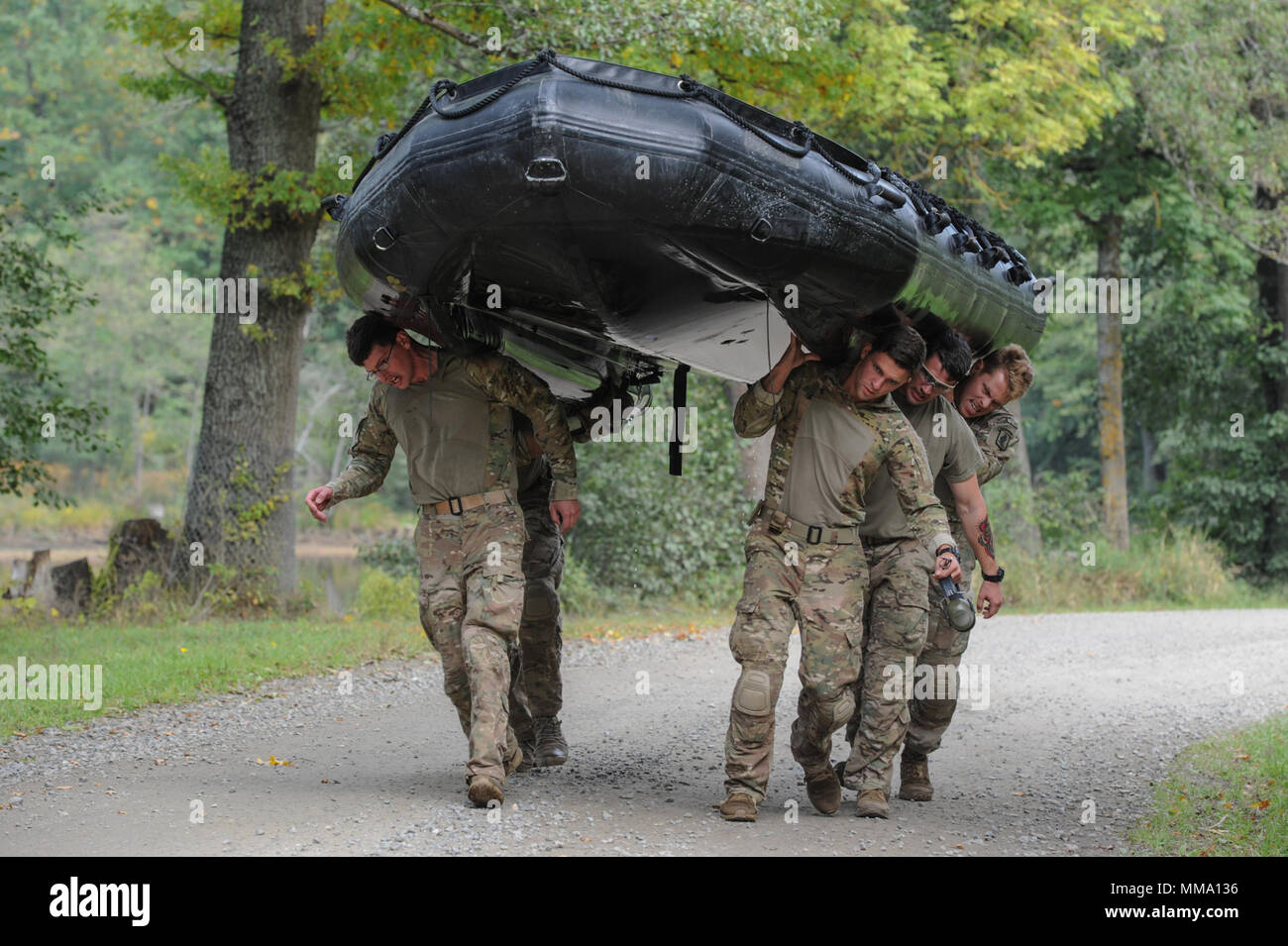 U.S. Soldiers with 173rd Airborne Brigade carry an inflatable landing ...