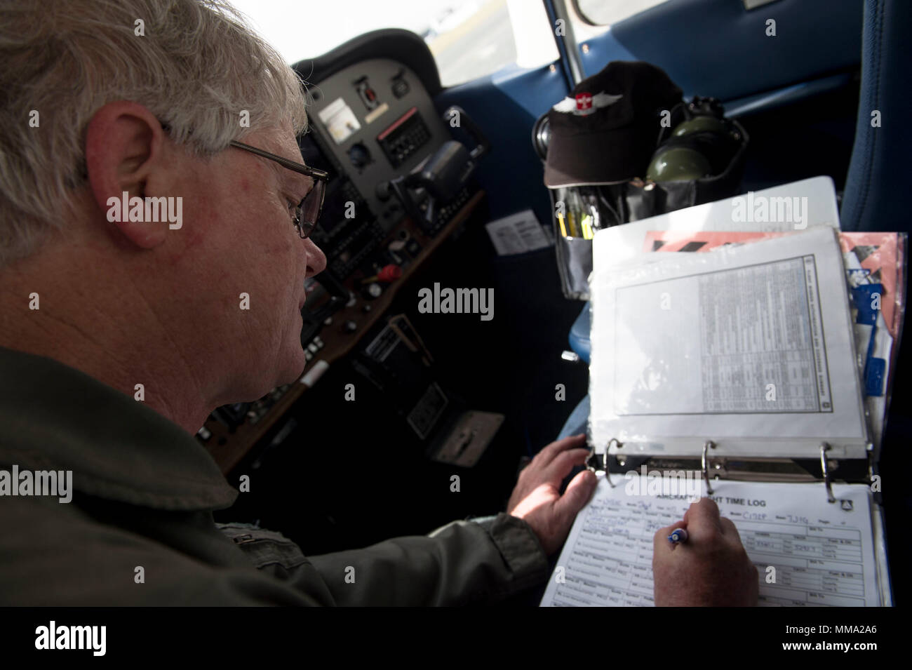 Captain William Henry a Civil Air Patrol pilot does his post-flight ...