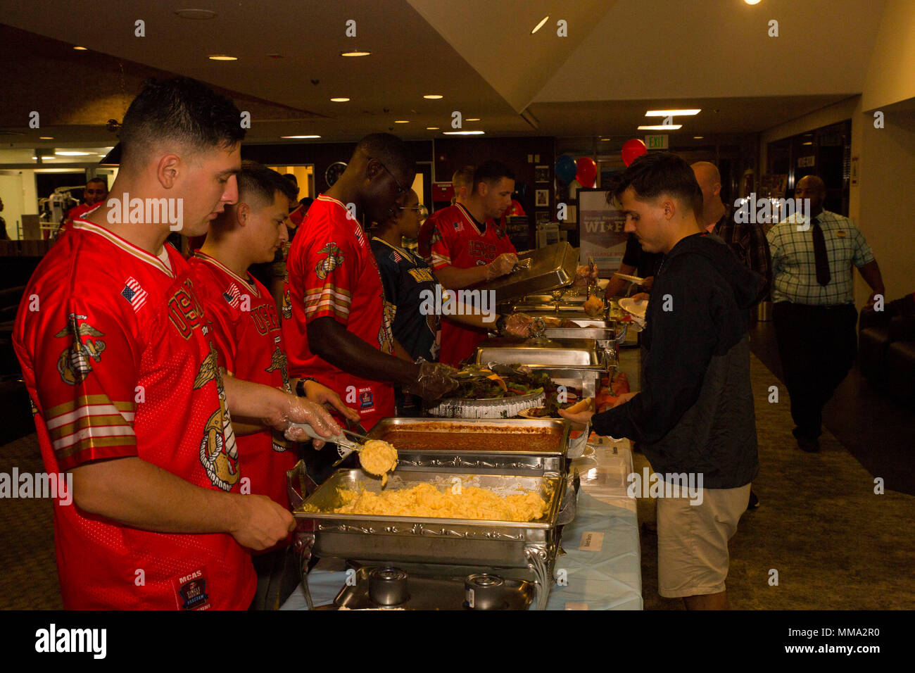 U.S. service members serve dinner during the 20th annual Single Marine ...