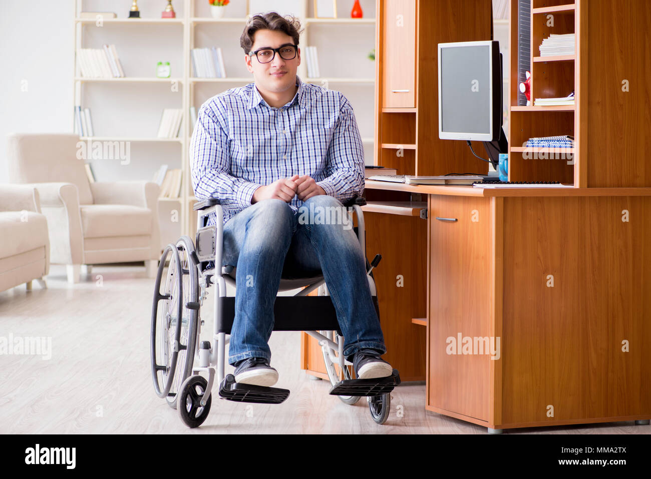 Disabled student studying at home on wheelchair Stock Photo - Alamy