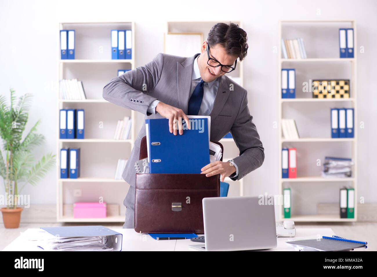 Employee with too much work taking it home Stock Photo - Alamy