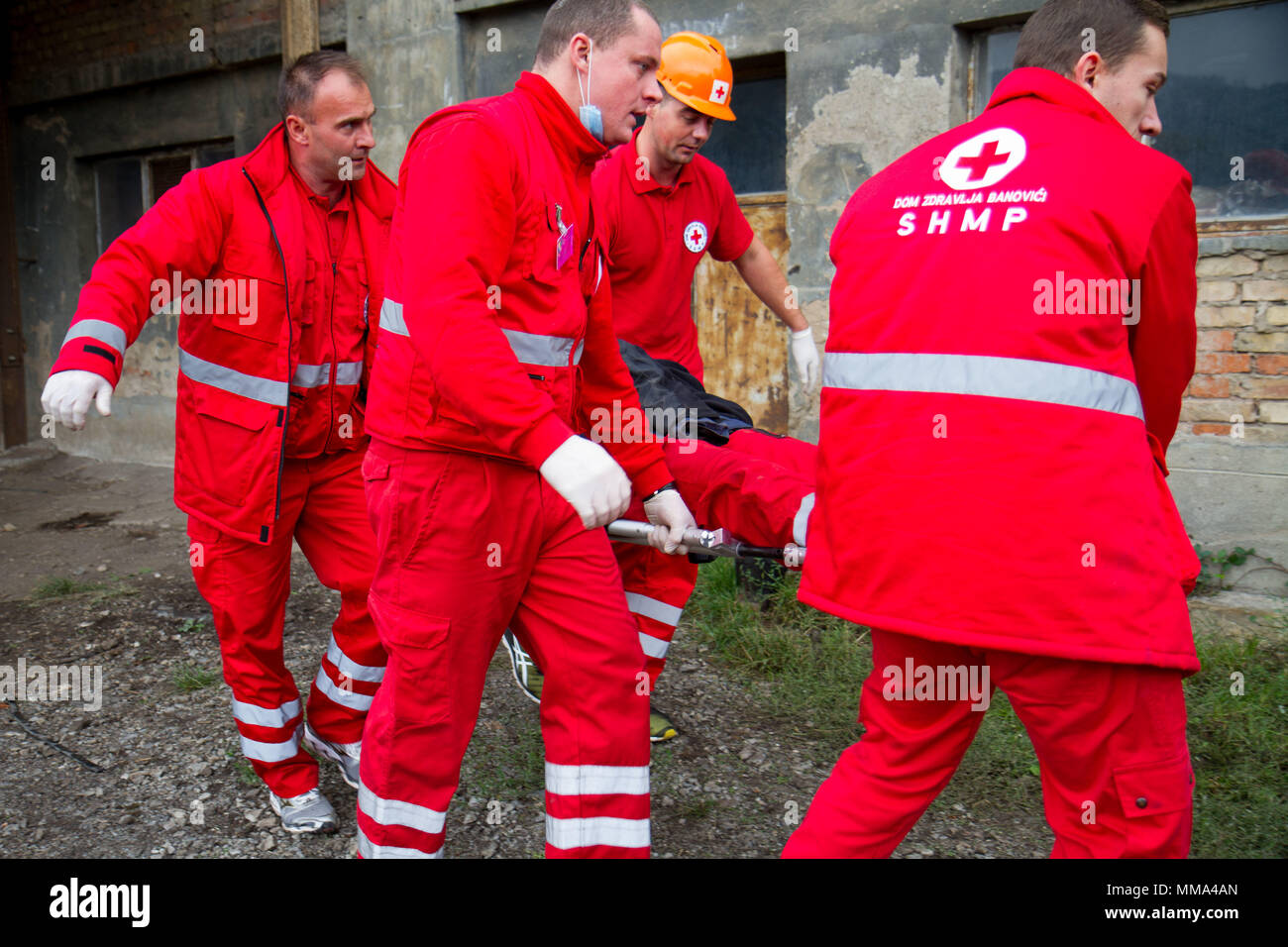 Local paramedics lift a litter carrying a role-player casualty to an ...