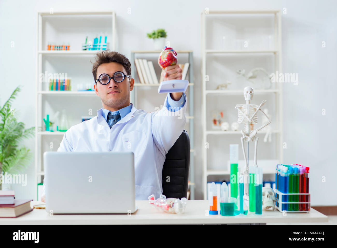 Funny doctor having fun in hospital lab Stock Photo - Alamy