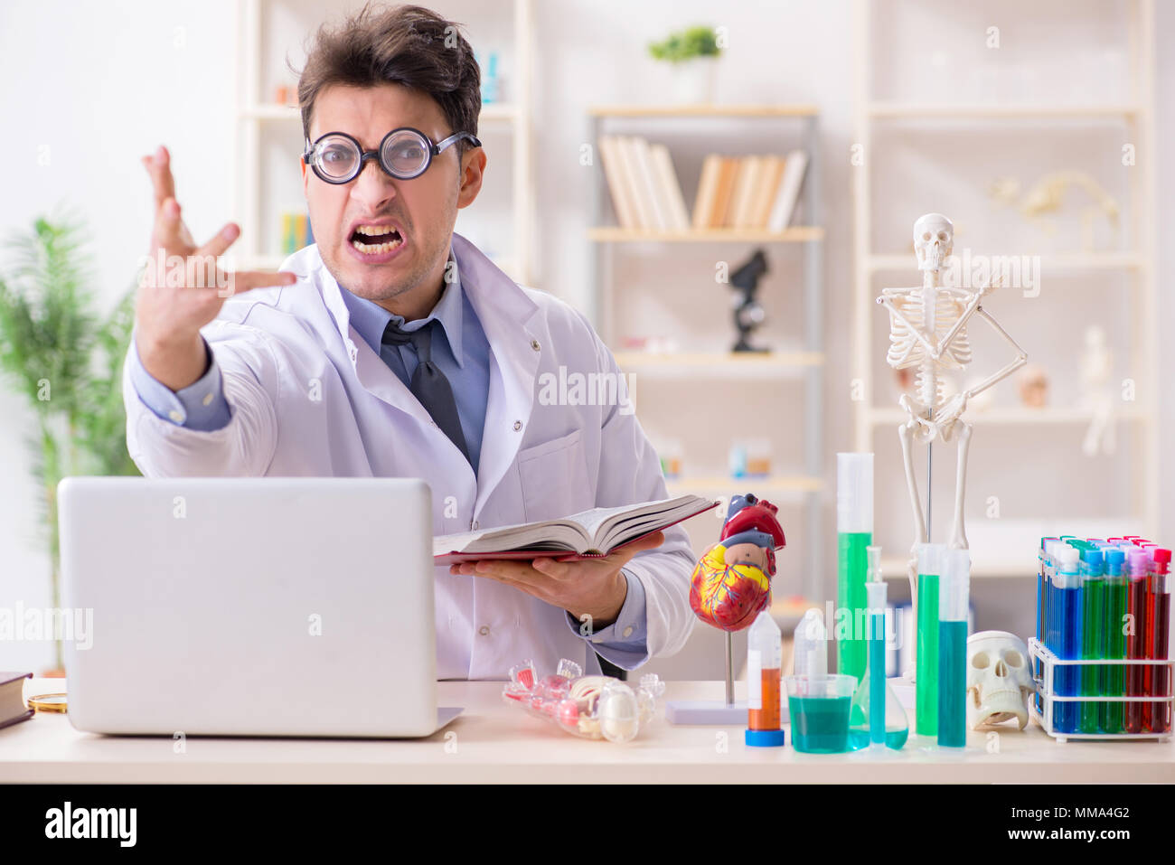 Funny doctor having fun in hospital lab Stock Photo - Alamy