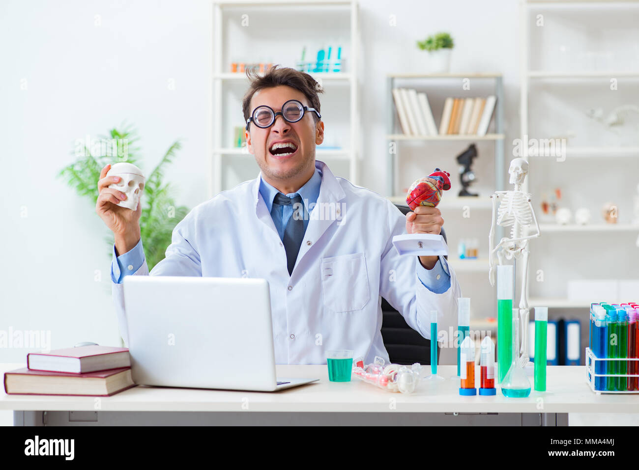 Funny doctor having fun in hospital lab Stock Photo - Alamy