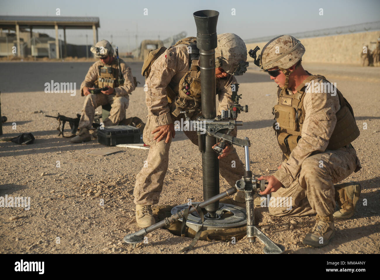 U.S. Marines adjust an 81mm mortar to improve defensive posture near ...