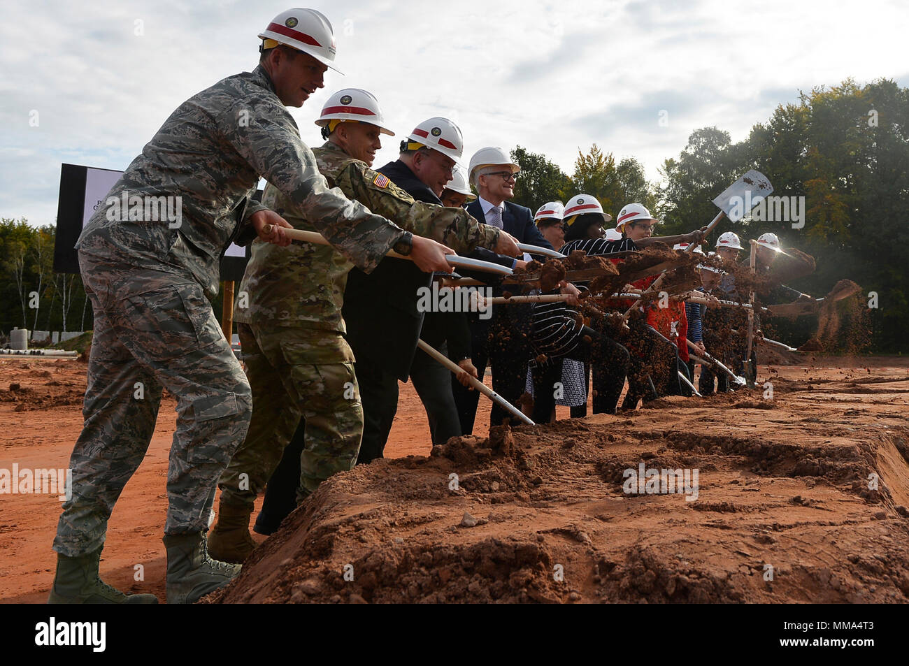 Military and civilian officials participate in a groundbreaking ...