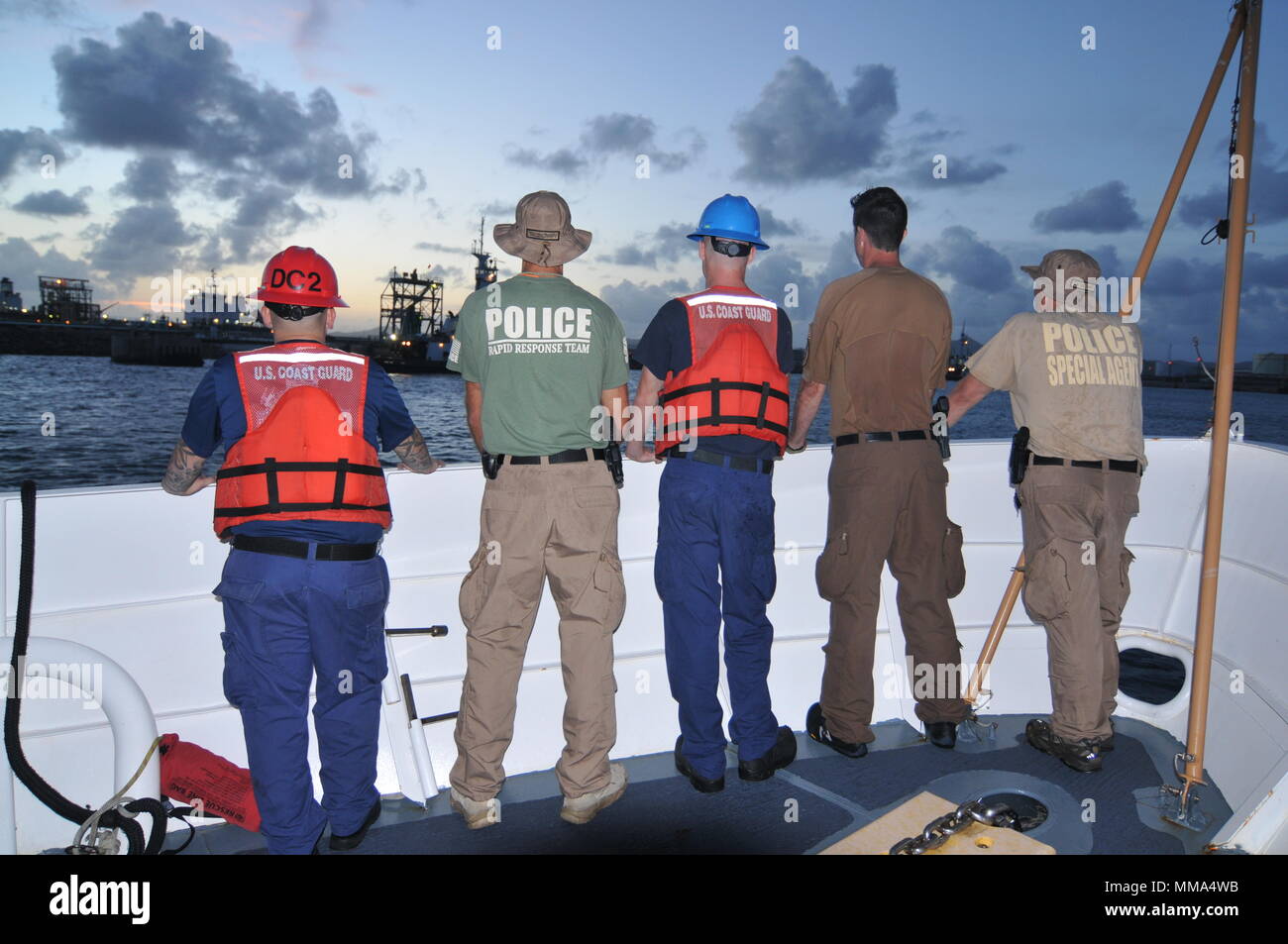 Coast Guard Cutter Winslow Griesser crew members scan piers in Lime ...