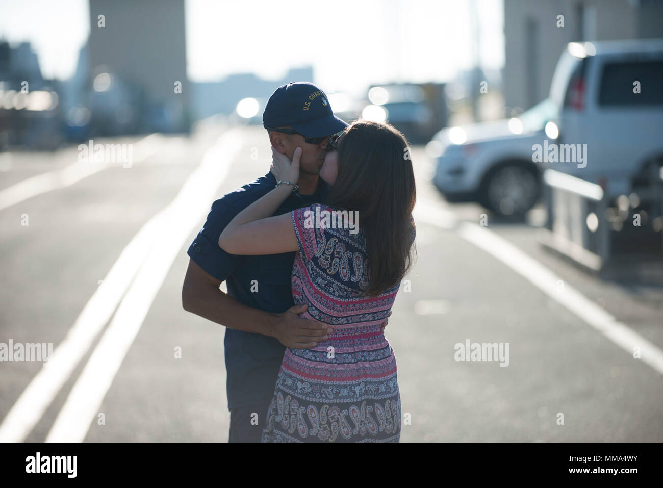 A Coast Guard Cutter Valiant crewmember embraces his loved one Friday ...
