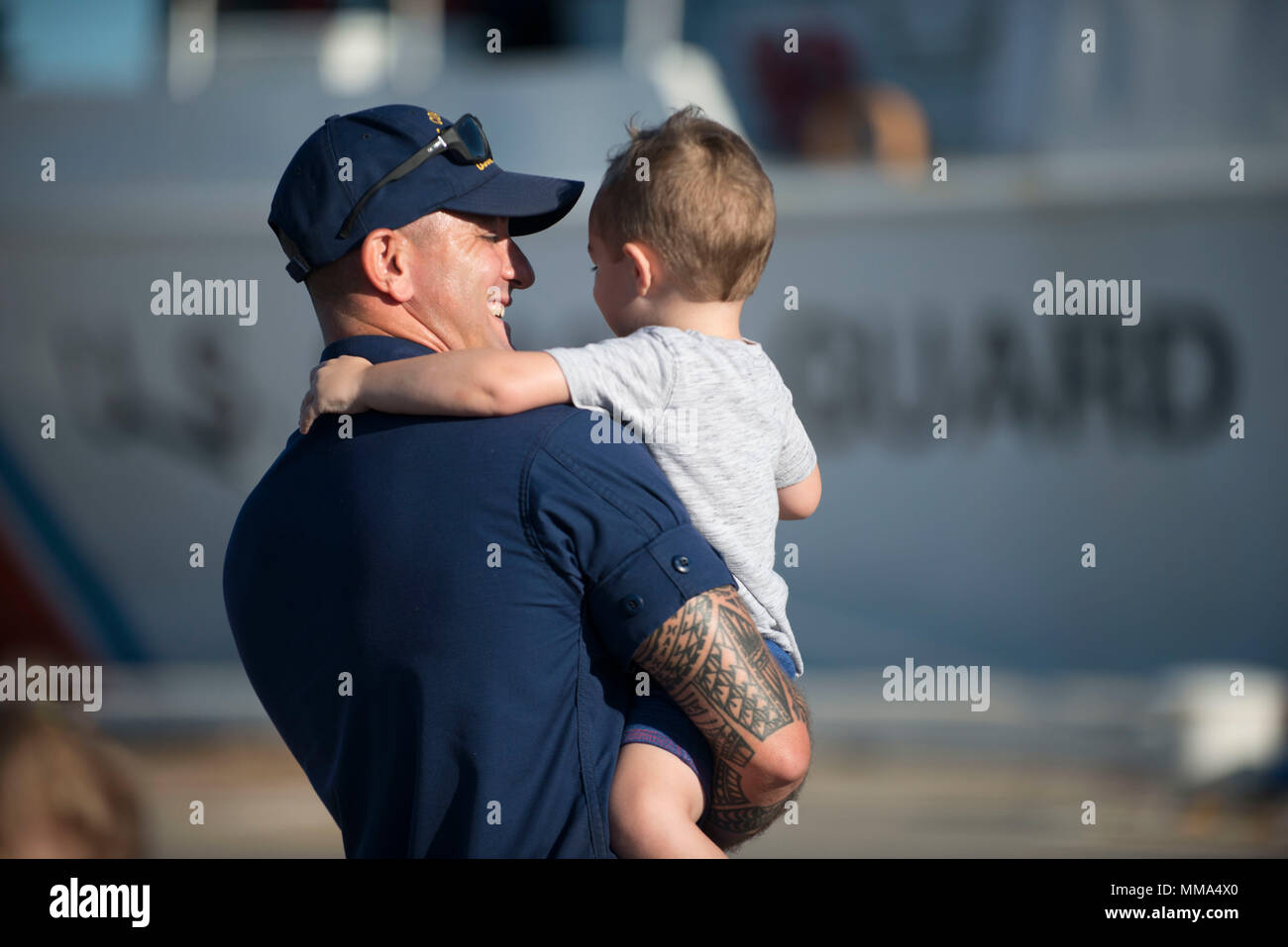 A Coast Guard Cutter Valiant crewmember hugs his child Friday, Sept. 29 ...