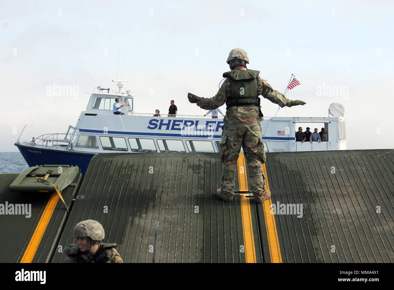 Soldiers aboard a 130 foot Improved Ribbon Bridge from the Michigan ...