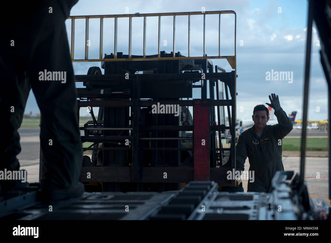 U.S. Air National Guard Senior Master Sgt. Pheliz Vazquez is guided by ...