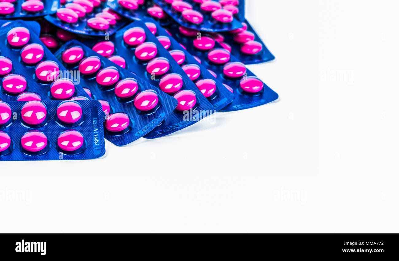Ibuprofen in pink tablet pills pack in blue blister pack isolated on ...
