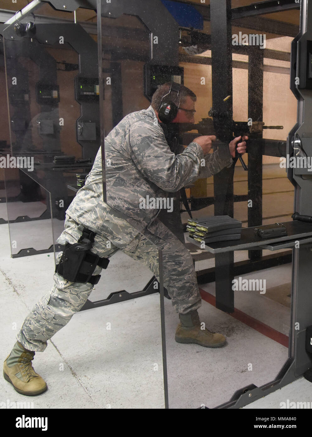 Maj. Gen. Timothy Leahy, 2nd Air Force commander, fires an M4 carbine ...