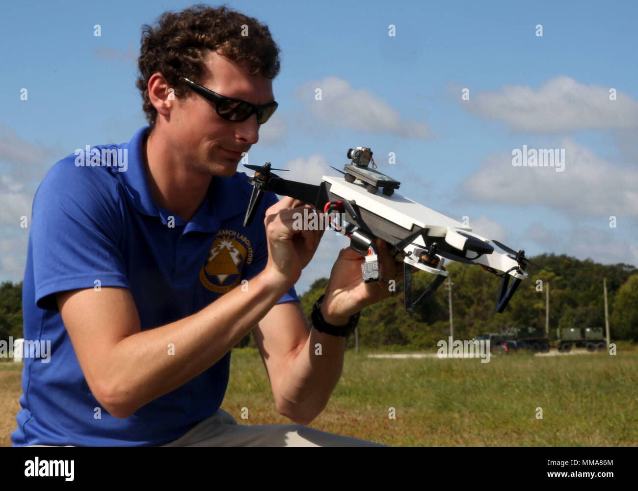 A U.S. Research Laboratory employee inspects a 3D printed unmanned ...