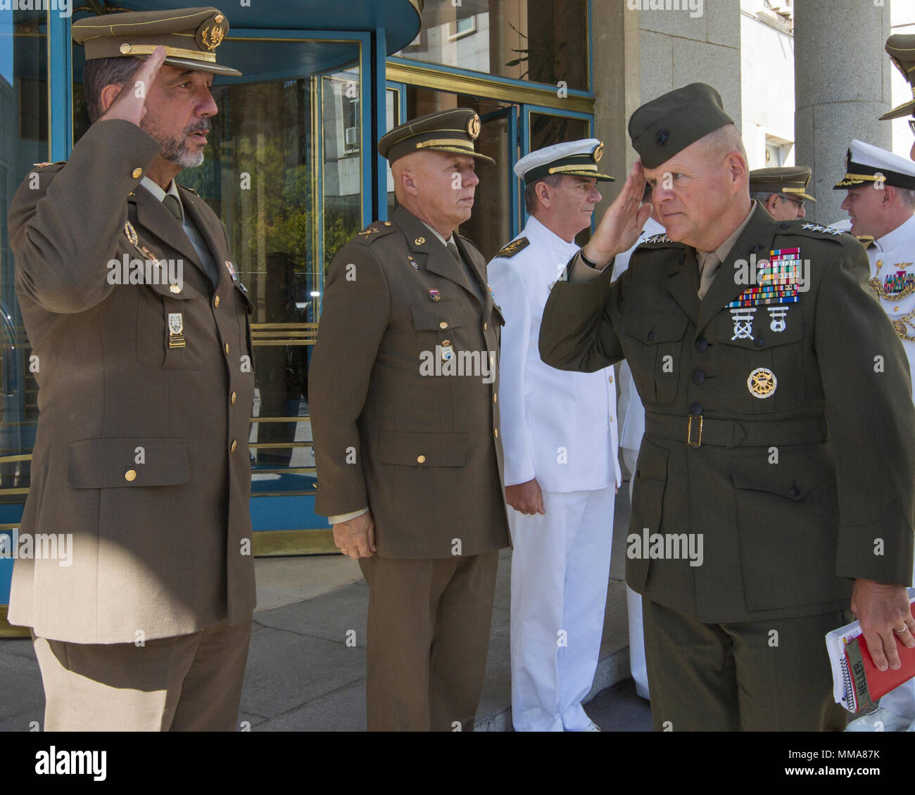 Commandant of the Marine Corps Gen. Robert B. Neller, right, salutes a ...