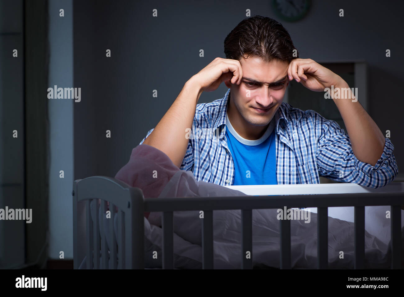 Young father under stress due to baby crying at night Stock Photo - Alamy