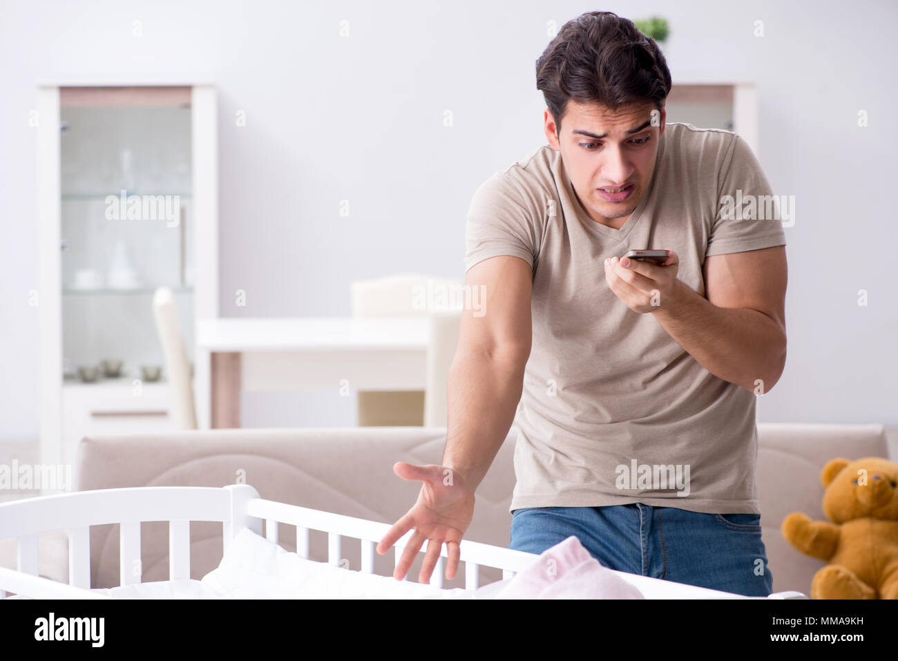 Young father dad frustrated at crying baby Stock Photo - Alamy