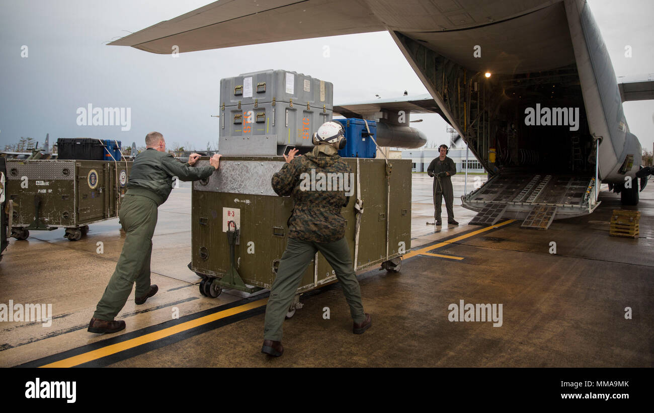 U.S. Marines with Marine Helicopter Squadron One (HMX-1) load a KC-130J ...