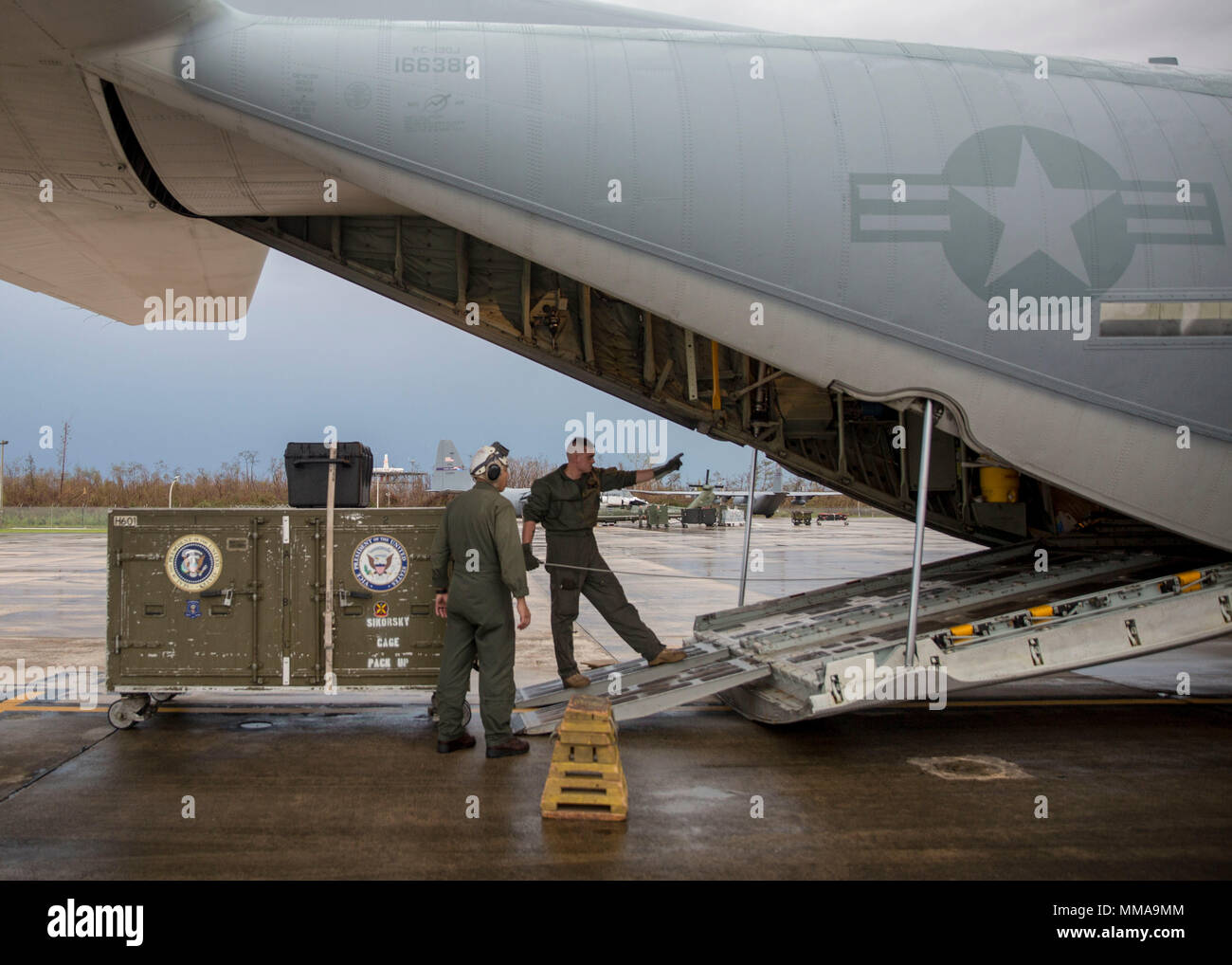 U.S. Marines with Marine Helicopter Squadron One (HMX-1) load a KC-130J ...