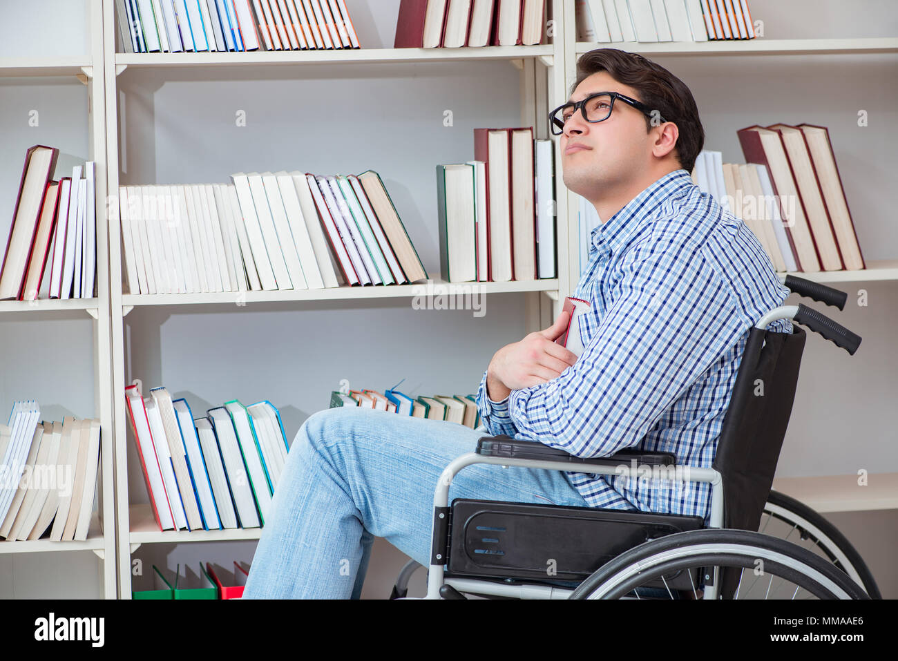 Disabled student studying in the library Stock Photo - Alamy