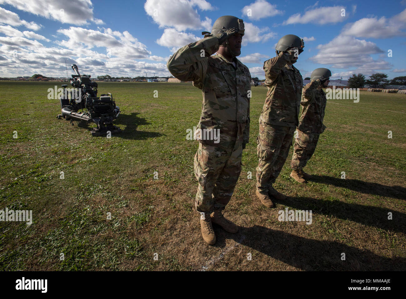 U.S. Army Soldiers of B Battery, 3-112th Field Artillery, New Jersey Army National Guard, salute ...