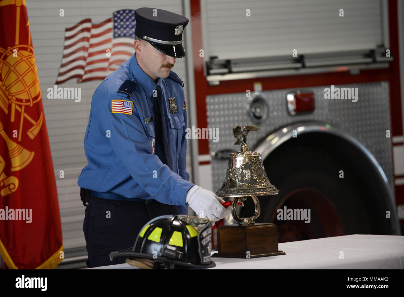 Matthew Croteau, Offutt firefighter, rings a bell twenty times during a ...