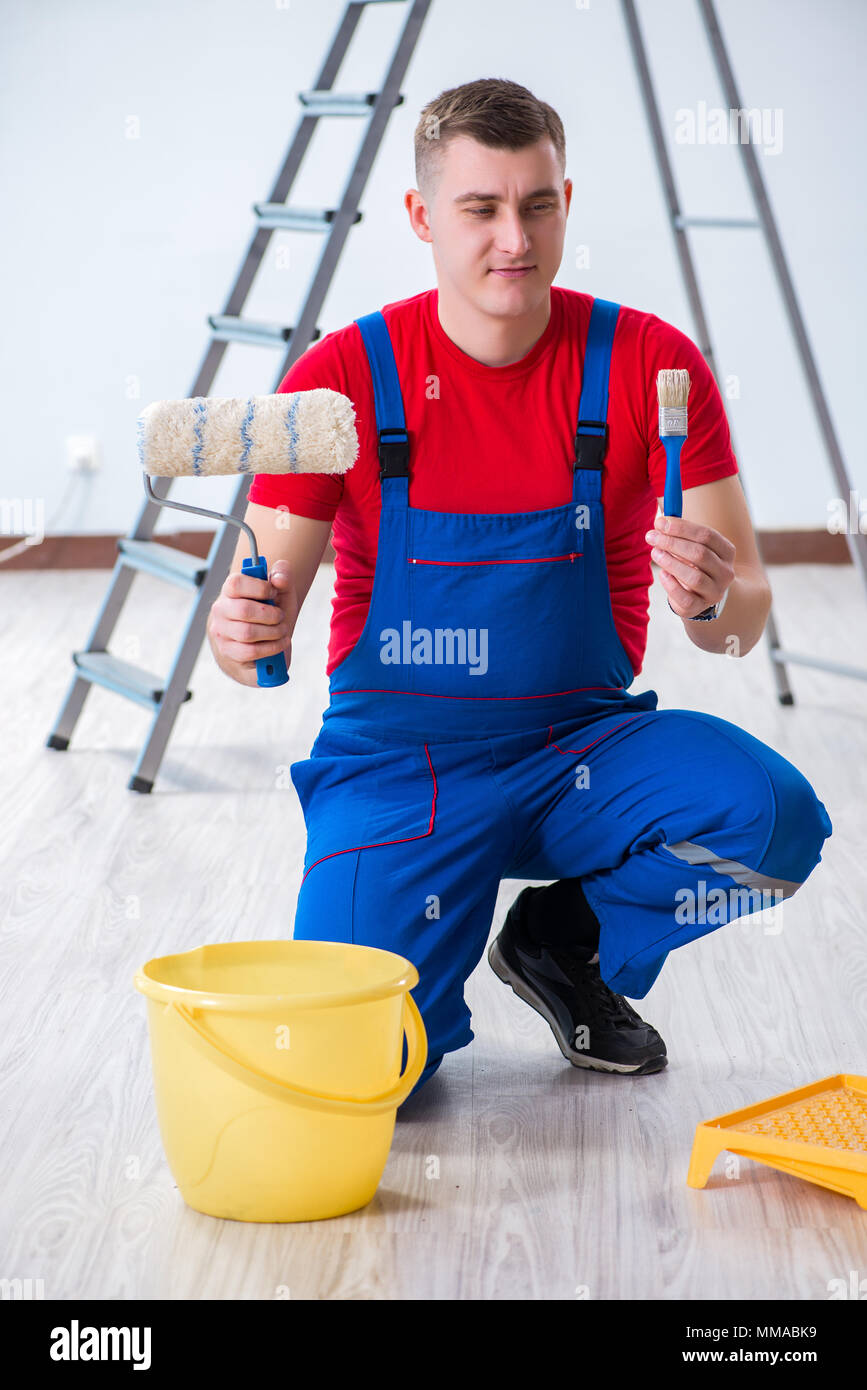 Male painter preparing for painting job at construction site Stock ...