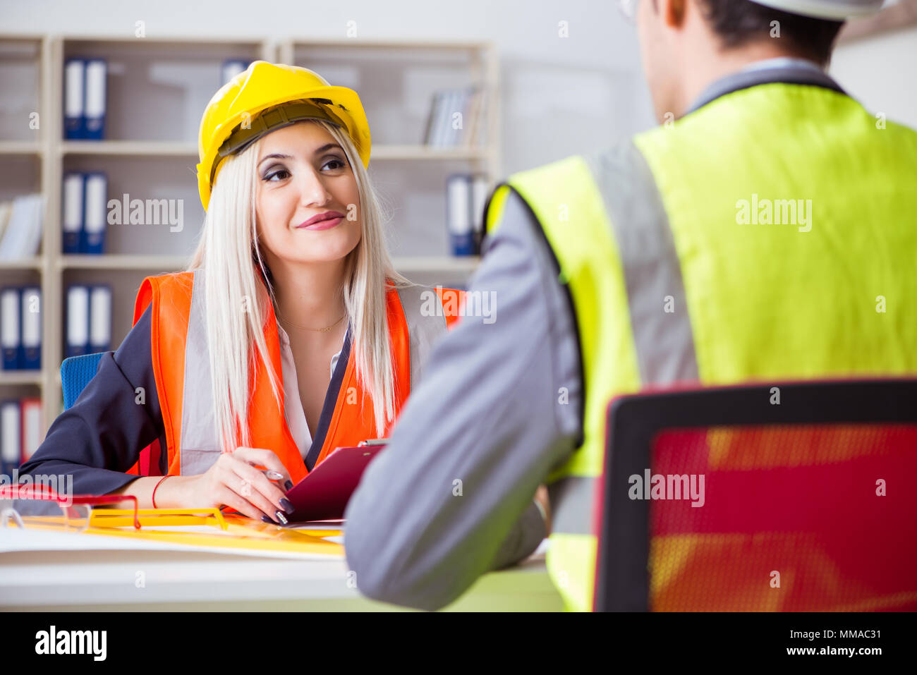 Construction workers having discussion in office before starting ...