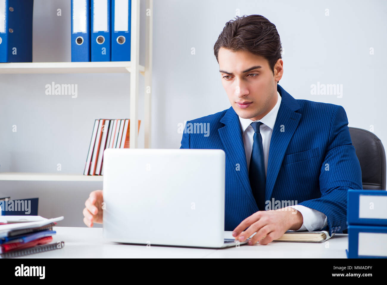 Young handsome businessman employee working in office at desk Stock ...