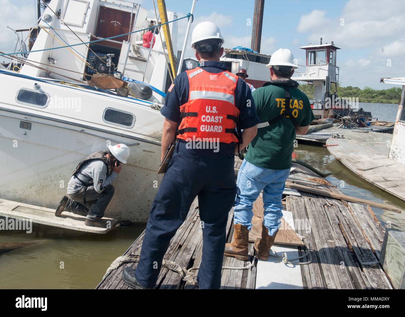 A contractor from Laredo Construction checks the stern of a refloated ...