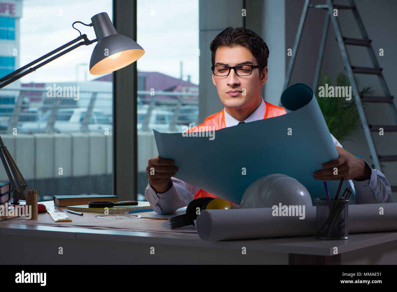 Construction architect working on drawings late at night Stock Photo ...