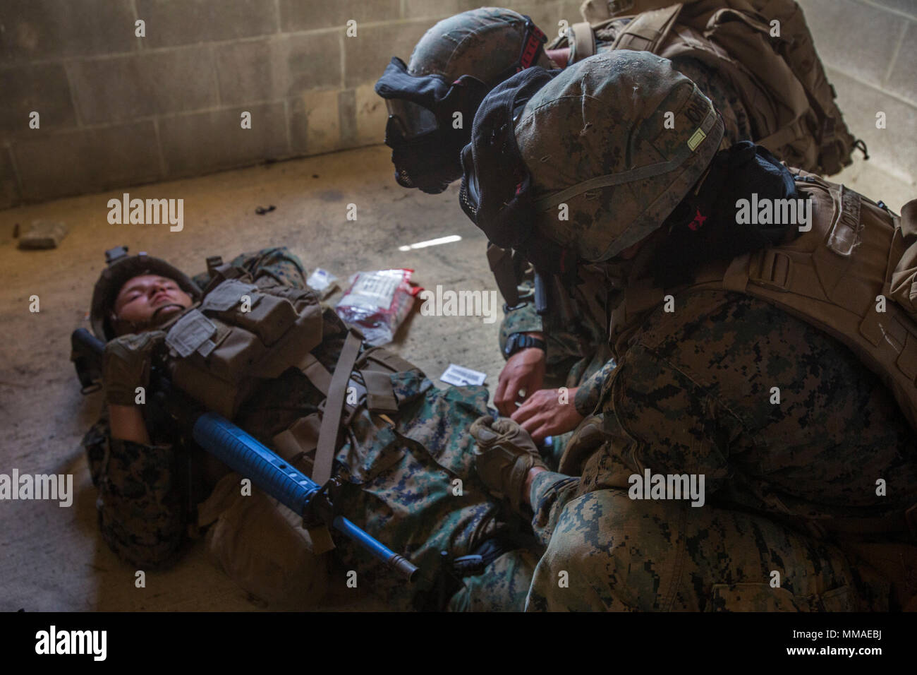 Marines with 2nd Battalion, 8th Marine Regiment apply tourniquets to a casualty during a ...