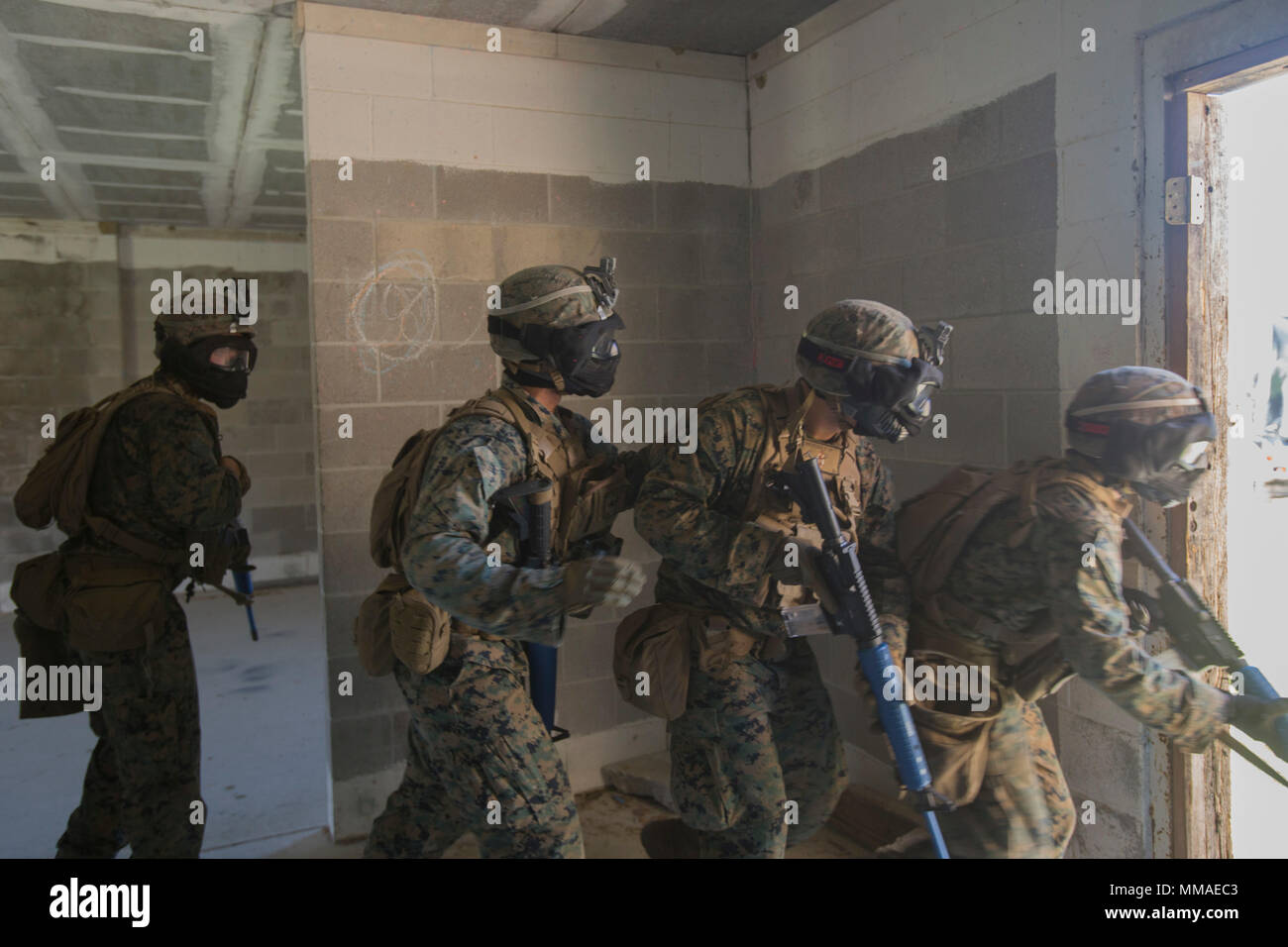 Marines with 2nd Battalion, 8th Marine Regiment maneuver to the next building during a military ...