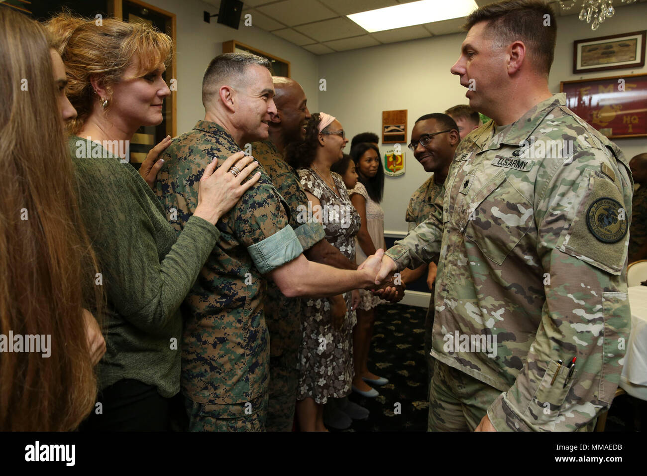 U.S. Marine Corps Col. Jordan Walzer and Col. James Ryans shake hands ...