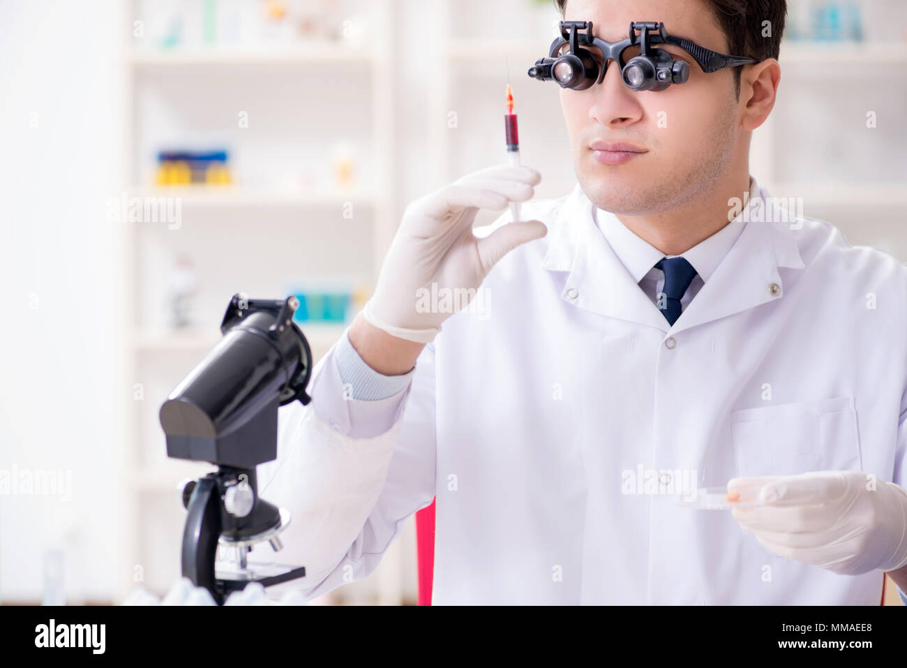 Doctor chemist working on blood samples in lab Stock Photo - Alamy