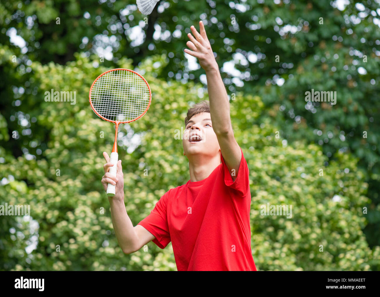 Teen boy playing badminton in park Stock Photo - Alamy